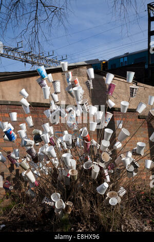Litter Bush in Manchester, UK, adorned with Polystyrene white cups, an ...