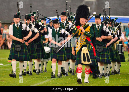 Scottish traditional music pipe major with pipe band marching down ...