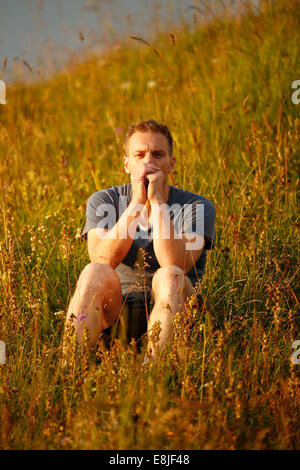 Man praying outside Stock Photo - Alamy