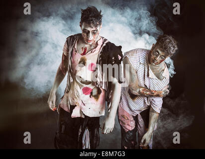 Two male zombies standing on white background, full body shot, looking ...