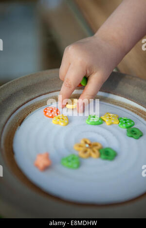 Baby using pincer grasp to pick up food, developmental milestones, ages ...