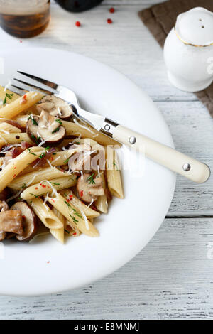 Appetizing penne pasta with mushrooms, cheese parmesan creamy sauce and ...