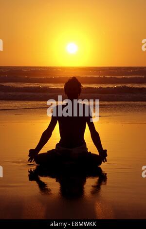 Man meditating yoga at sunset. meditation concept Stock Photo - Alamy
