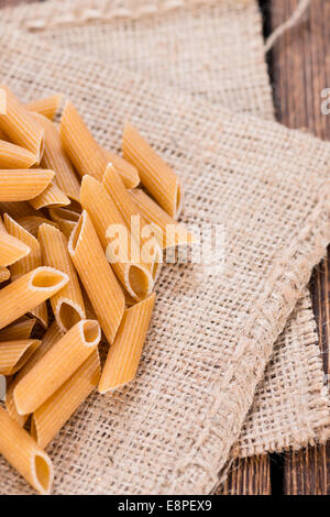 Wholemeal Penne as close-up shot on vintage wooden background Stock ...