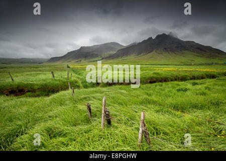 Beautiful landscape of Icelandic field with fence and mountain Stock ...