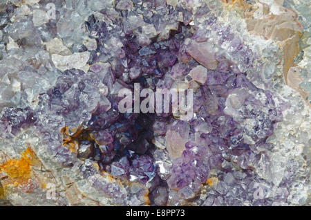 Amethyst druse over beige rock Stock Photo - Alamy