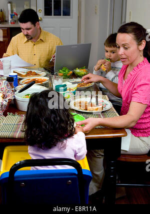 Distracted family at the dinner table Stock Photo - Alamy