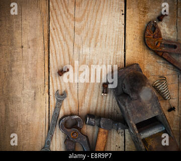 Dirty set of hand tools on a wooden background. Old rusty tools ...
