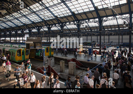 Passengers getting off trains and walking towards ticket gates at ...