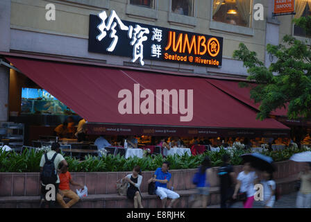 Jumbo Seafood Restaurant with people dining at outdoor riverside tables ...
