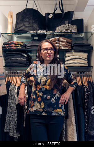 female, lady shopkeeper, saleswoman, in her clothes shot in Brighton ...