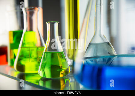 Close up of beakers with solutions on shelf in lab Stock Photo - Alamy