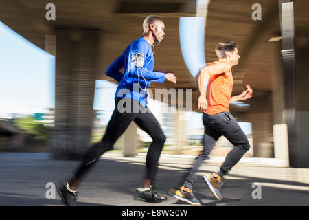 Men running together through city Stock Photo - Alamy