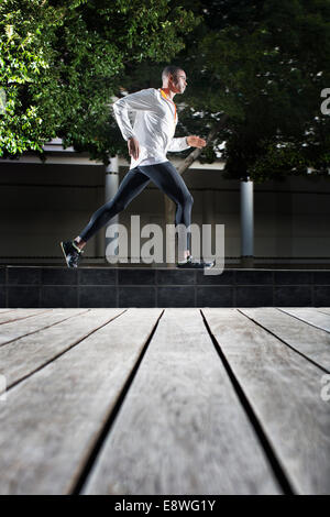 Man running through city streets Stock Photo - Alamy