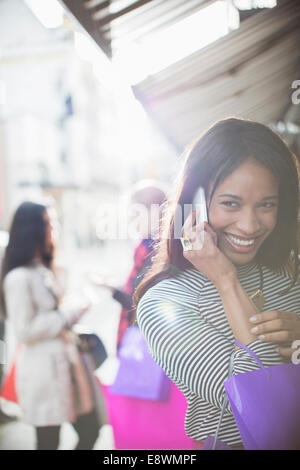 Young hispanic woman speaking on the phone about bills depressed and ...