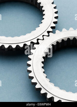 A close-up view of two interlocking circular objects featuring intricate patterns and textures ...