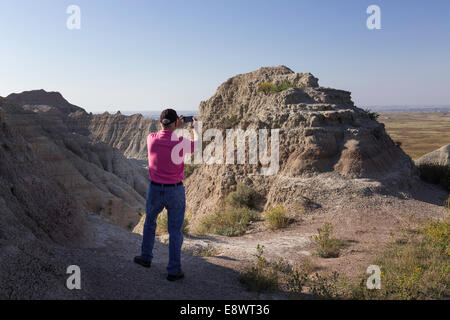 Tourist taking a photo on a barren beach on the South Georgia island in ...
