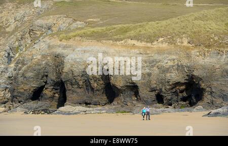 A couple walking along Penhale Sands Perranporth Beach Cornwall England ...
