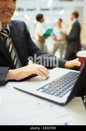 Young african american businessman typing a message on a phone while ...