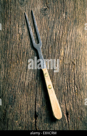Very old rusty vintage silver fork on a black cement texture background ...