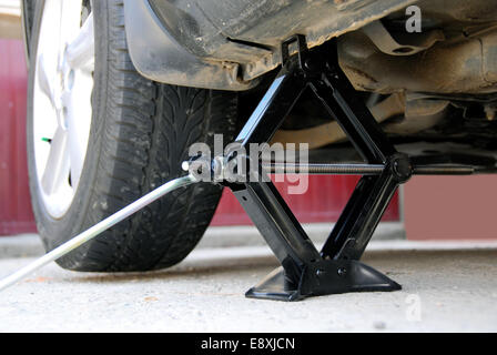 mechanic with screwdriver changing car tire Stock Photo - Alamy