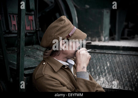 Man sat smoking a cigarette Stock Photo - Alamy
