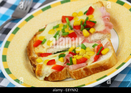 Toast with mozzarella, ham, red pepper and sweetcorn Stock Photo - Alamy