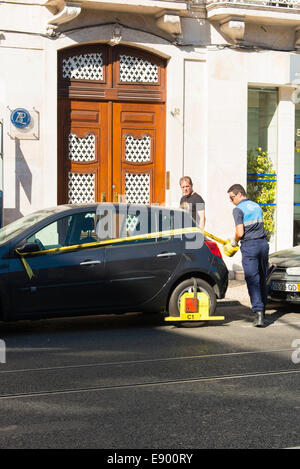 A Wheel Clamp, parking boot, around the wheel of a Jeep automobile ...