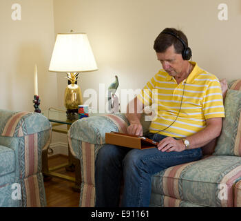 Boomer reading on tablet computer Stock Photo - Alamy