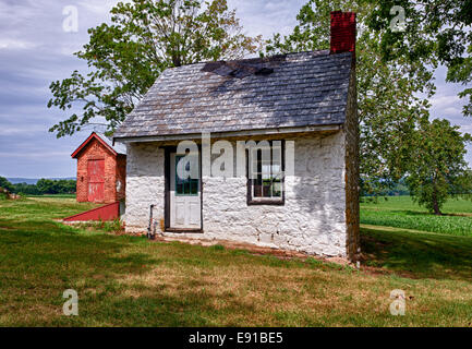 Old white washed farm cottage with slate roof and adjoining barn Stock ...