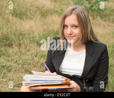 schoolgirl writes lessons in notebook. online learning for laptop Stock ...