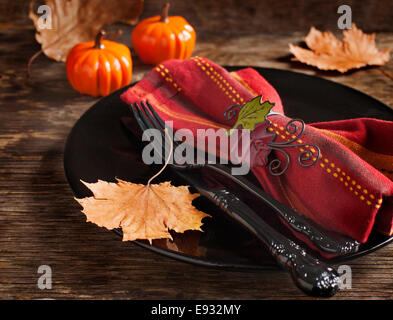 Autumn table setting with plate, pumpkin and candles Stock Photo - Alamy