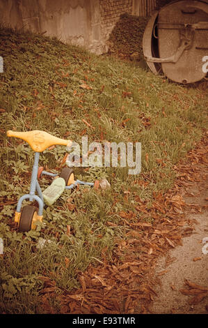 An unnecessary forgotten toy on the grass. A torn teddy bear lies on ...