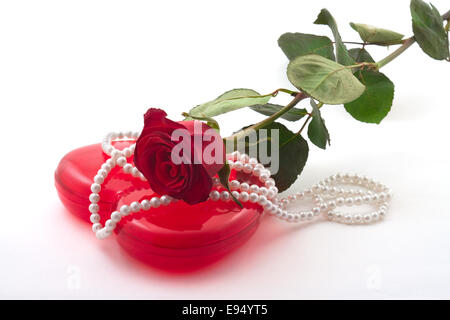 Gifts for Valentine's Day celebration and beads on color background ...