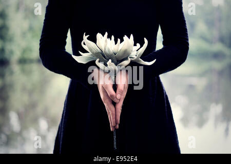 woman detail with a flower in her hands Stock Photo - Alamy