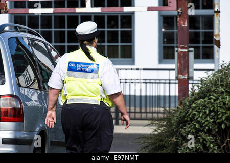 A civil enforcement officer patrolling a car park in Southend Stock ...