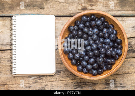 Fresh wild berries with blank recipe book on wood background Stock ...
