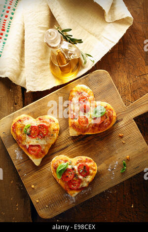 Wooden board with tasty heart shaped cookies on light background ...