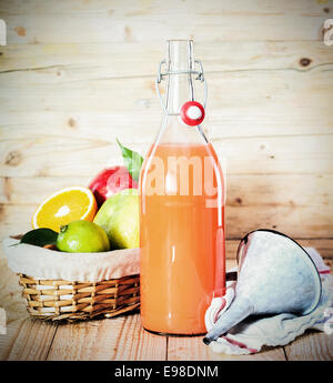 Small glass bottle of fresh juice on white background Stock Photo - Alamy