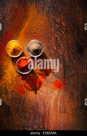 Cooking using fresh ground spices with mortar and small bowls of spice ...