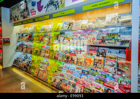 Magazines for sale on a shelf in a newsagent shop store in the Uk Stock ...