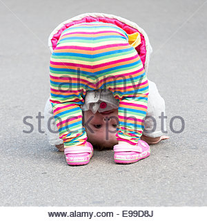 little girl looking between her legs into the camera Stock Photo ...