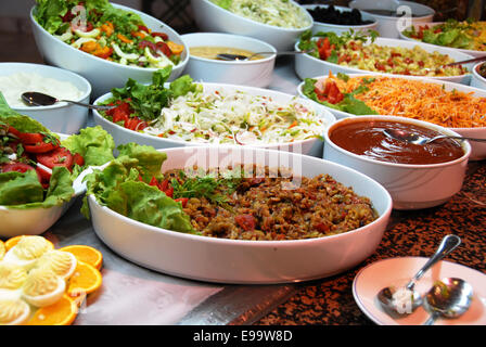 Canteen food in buffet with white dishes in stainless steel self ...