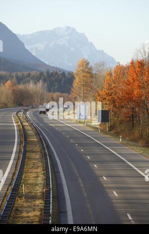 Automobile highway on the background of mountains and a bridge over the ...