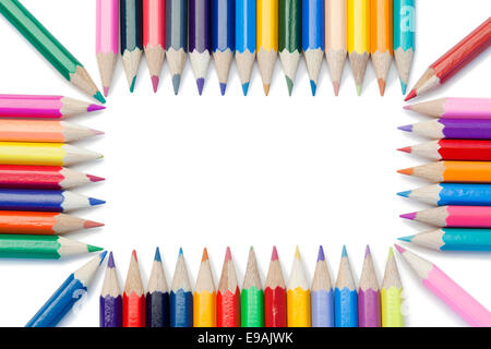 Colorful color pencils forming a rectangle frame on a piece of yellow ...