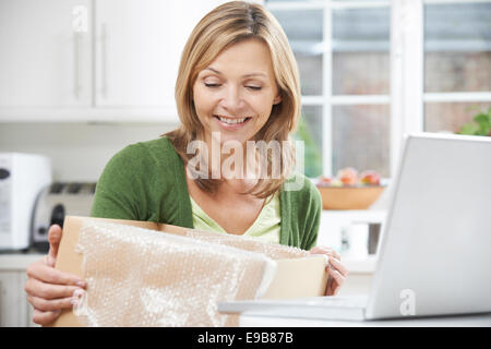 Happy Woman Unpacking On Line Purchase At Home Stock Photo - Alamy