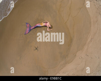 Young mermaid laying in the sand at the bottom of the sea Stock Photo ...