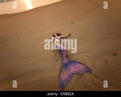 Young mermaid laying in the sand at the bottom of the sea Stock Photo ...