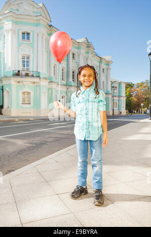 Hand holding a Colorful small balloon with colorful balloons on the ...