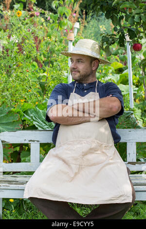 Man gardener with flowers on white Stock Photo - Alamy